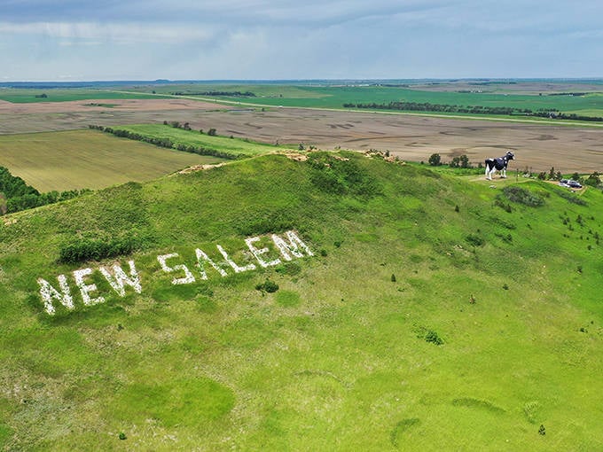 The town proudly announces itself with white stones on the hillside, while Sue serves as the exclamation point.