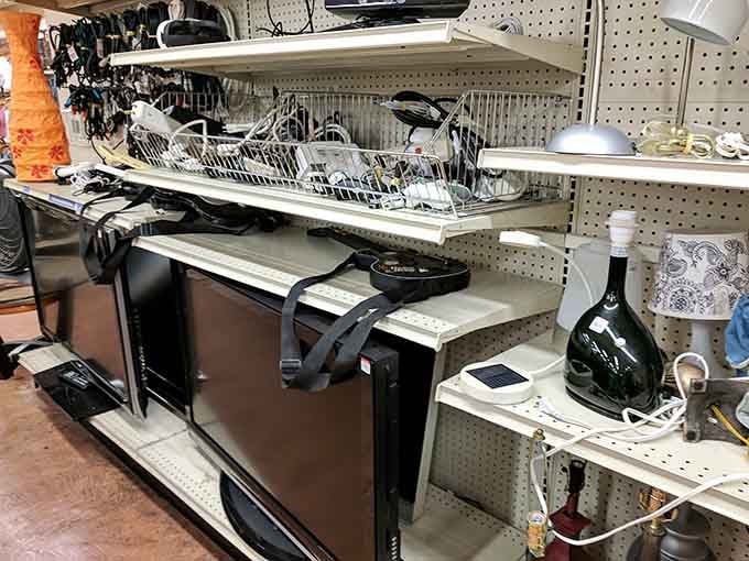 Electronics and small appliances lined up like a technology museum, where functional vintage meets surprisingly affordable pricing today.