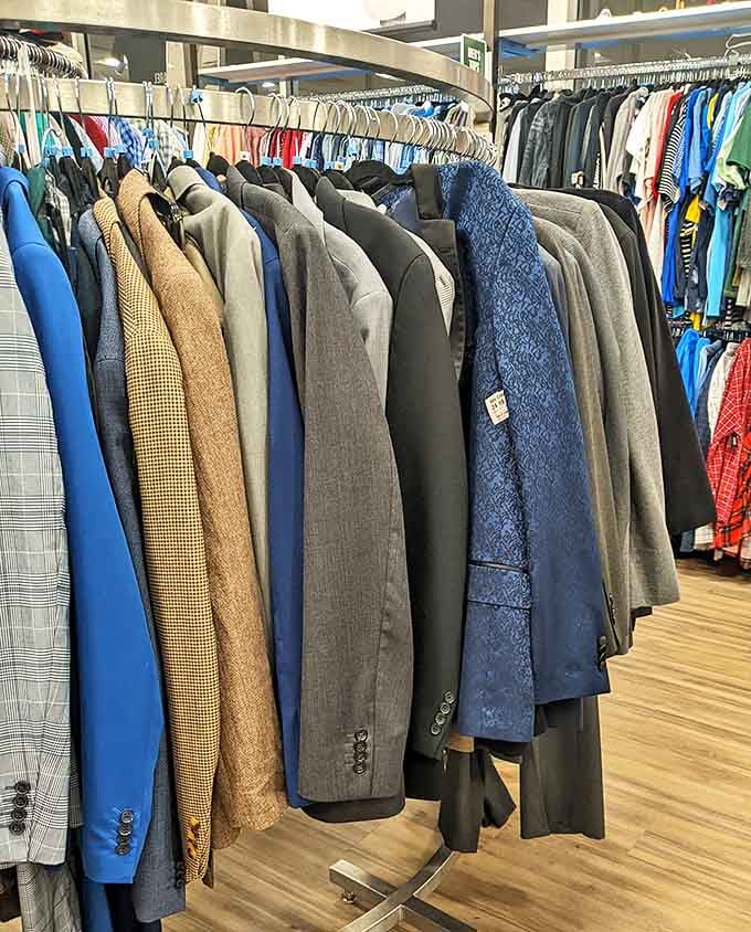 Men's blazers and suits lined up like well-dressed soldiers. Professional attire that won't require explaining mysterious charges to your significant other.