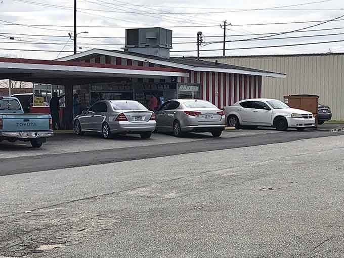 Parking lot packed with cars from all walks of life&mdash;luxury sedans next to work trucks. Good food is the ultimate social equalizer.