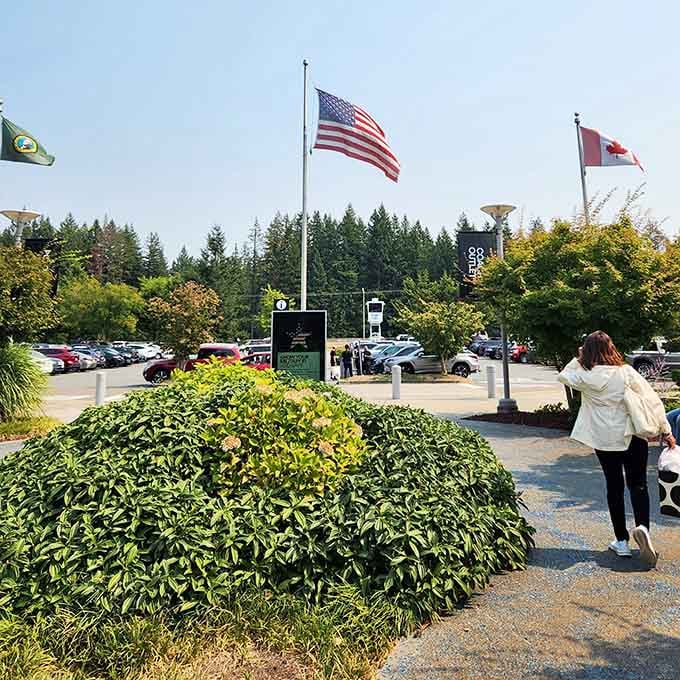 Three flags welcome international shoppers, with Canada's maple leaf acknowledging the northern neighbors who cross borders for bargains.