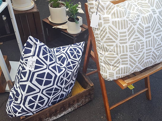Geometric patterns on handcrafted pillows and textiles bring modern design sensibilities to the vintage market, bridging past and present.