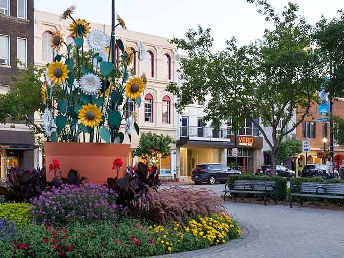 Monument Square bursts with colorful plantings and whimsical sculptures, creating a downtown gathering space that actually makes you want to gather.