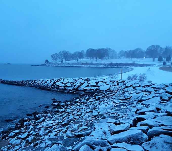 Winter transforms Hole in the Wall Beach into a hushed blue dreamscape where hardy New Englanders find solace in solitude.
