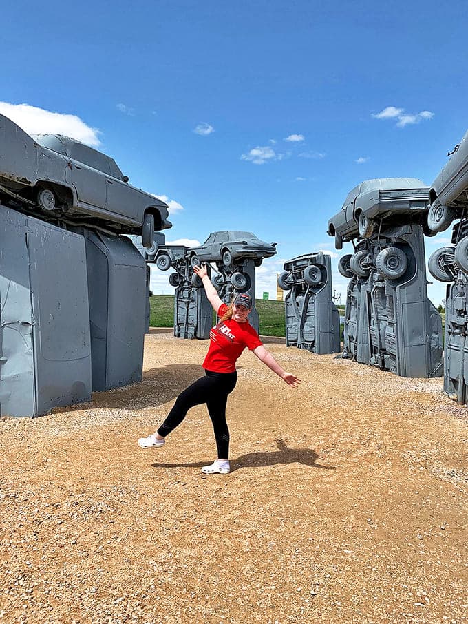 Visitors can't resist striking a pose among the automotive megaliths, pretending they possess the strength to hold up these Detroit dinosaurs single-handedly.