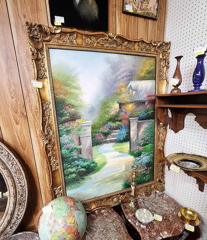 That ornate gold frame makes even a pastoral scene look museum-worthy. Paired with a vintage globe, it's a corner of cultured sophistication.