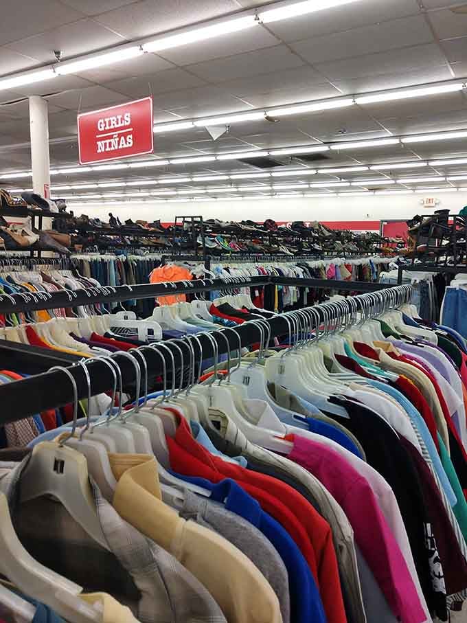 The women's section stretches to the horizon. Each rack contains potential outfit transformations waiting for the right person to discover them.