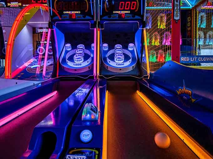 Skee-ball lanes glowing with neon promise, where your rolling technique matters more than your college degree ever did.