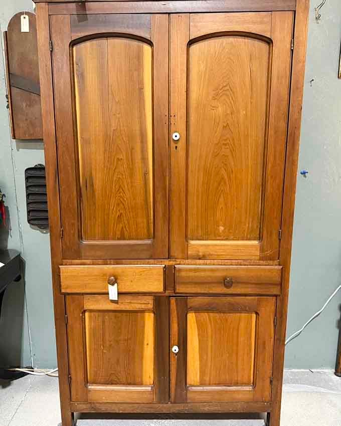 This wooden cabinet has more storage solutions than your entire modern closet system combined.