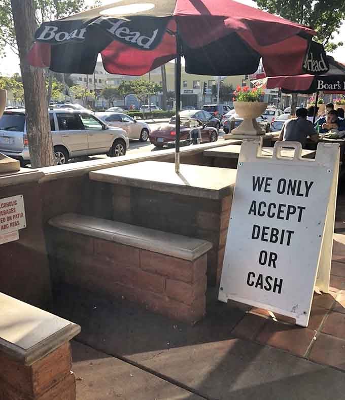 Outdoor seating with umbrellas where you can enjoy your sandwich while pretending you're not eating in a parking lot.
