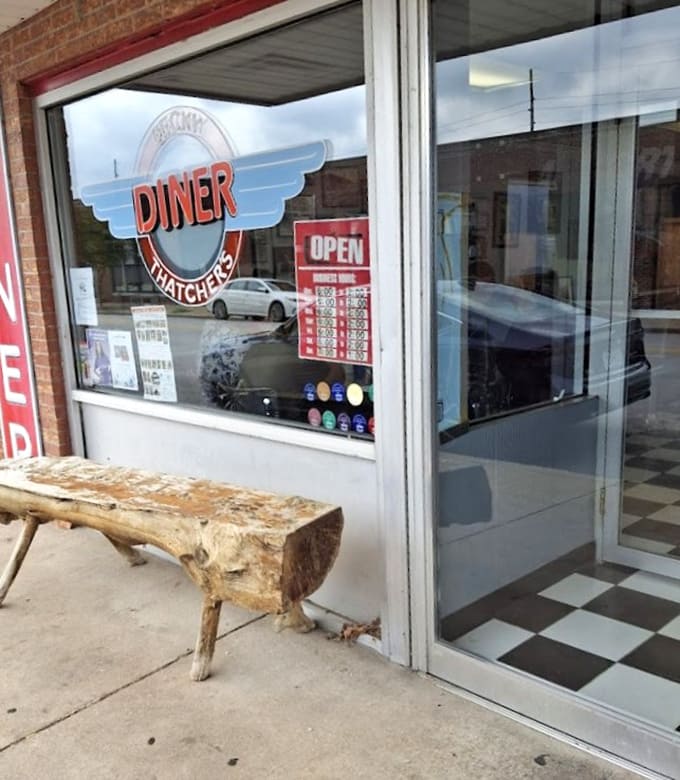 That rustic wooden bench outside welcomes you like an old friend, promising the comfort food adventure of a lifetime awaits.