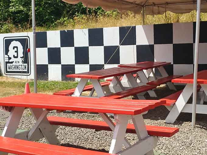 Outdoor seating with checkered racing flags because eating massive burgers should feel like a victory lap celebration.