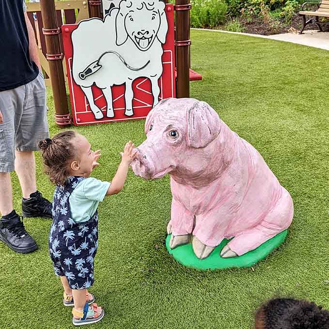 The pig statue has become an unexpected star, patiently posing for countless delighted toddler photo sessions.