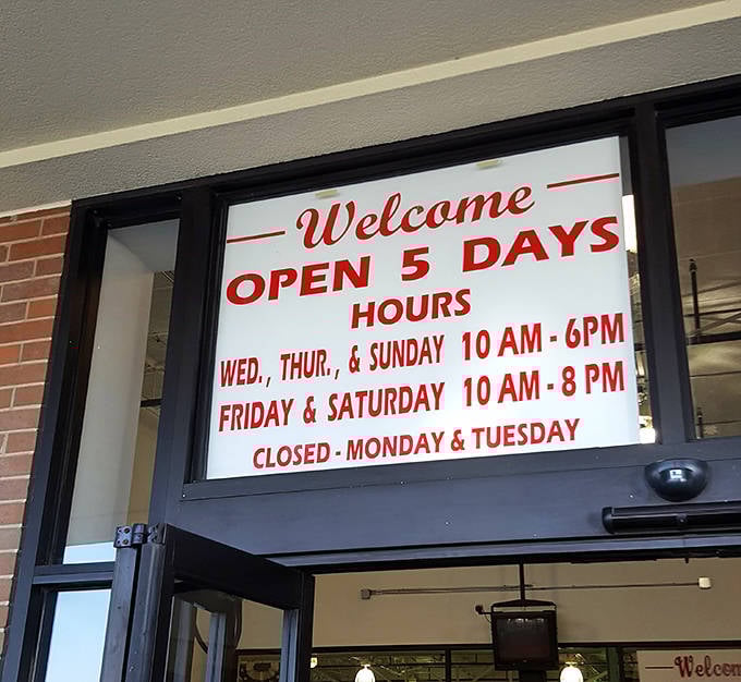 The hours sign reads like a treasure map&mdash;five days of opportunity to discover what you never knew you needed. Closed Mondays and Tuesdays to build anticipation.