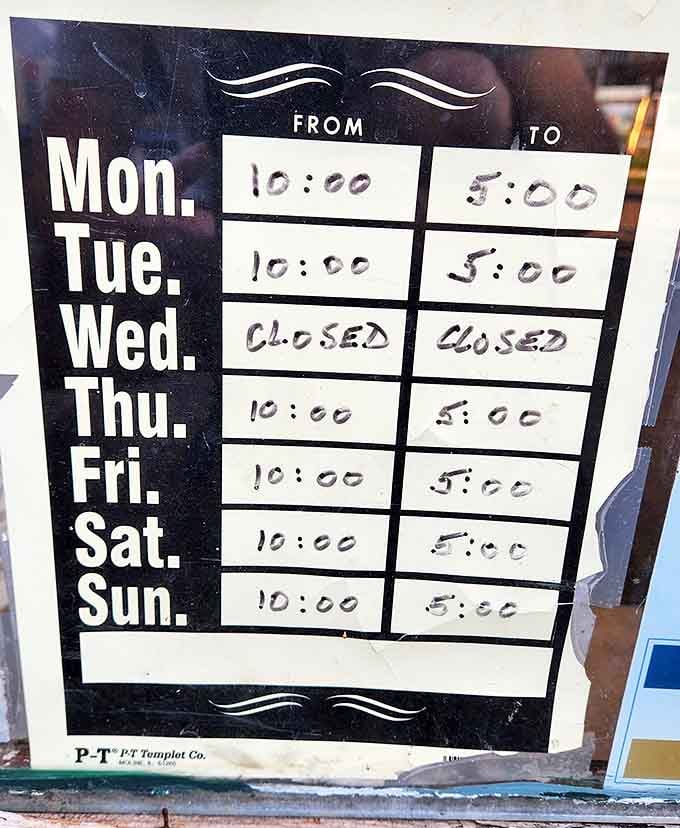The business hours sign&mdash;where "closed Wednesday" feels like a charming quirk rather than an inconvenience. Time moves differently in the world of antiquing.