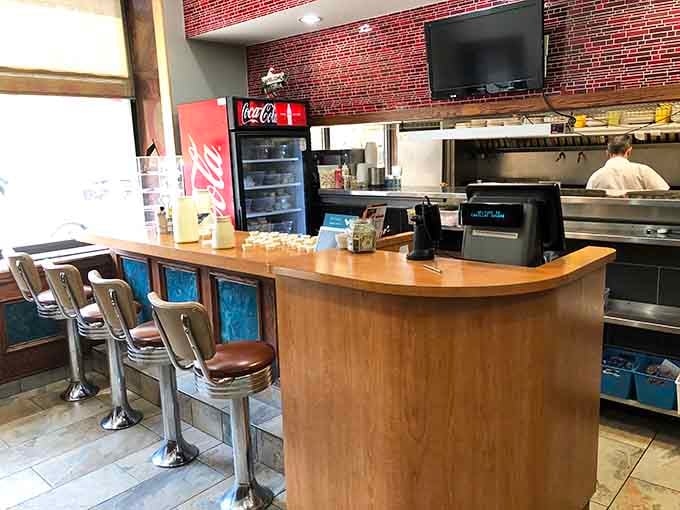 Classic diner counter seating where solo diners can enjoy their meal while watching the kitchen ballet unfold before them.