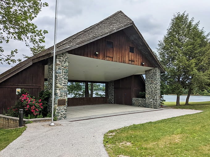 Stone pillars and lake views prove that picnic shelters can have architectural ambitions beyond basic coverage.