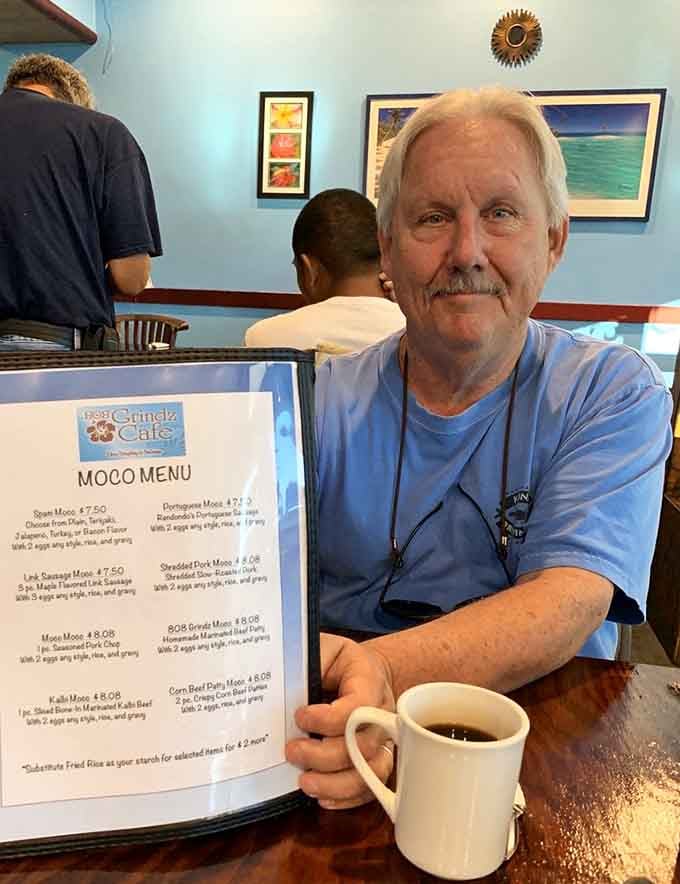 The look of a man who's discovered breakfast nirvana. That coffee mug isn't just holding Kona's finest&mdash;it's containing pure liquid happiness.