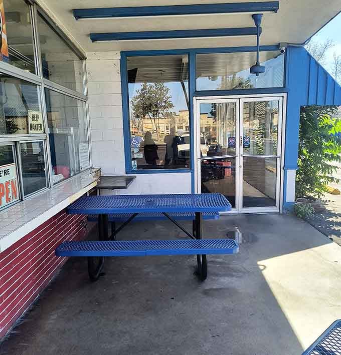 Simple blue picnic tables where countless meals and conversations have unfolded&mdash;the stage for everyday California dining.