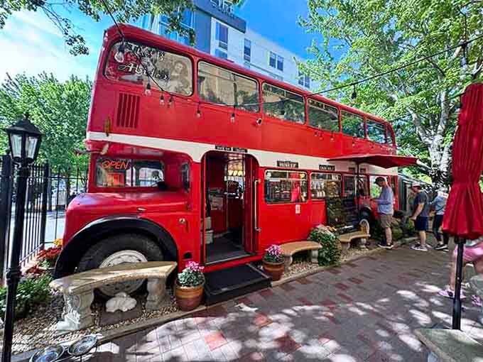 The full exterior view shows this stunning converted double-decker in all its cherry-red glory, impossible to miss or forget.