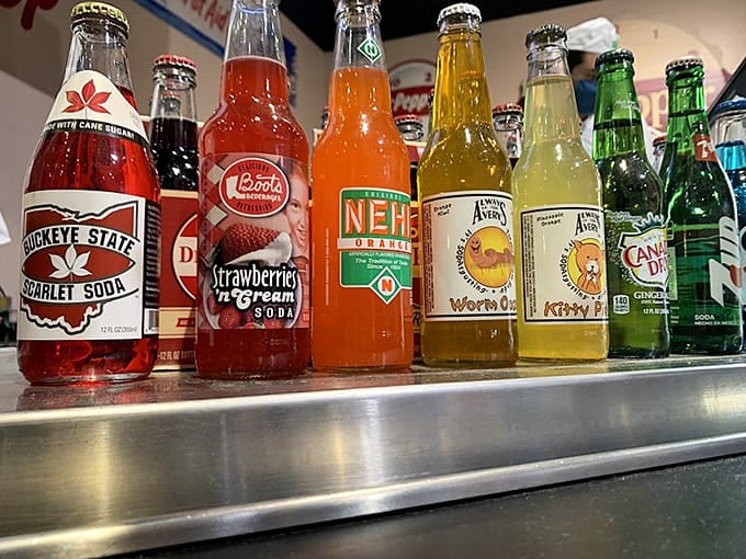Regional soda bottles line up like a rainbow of fizzy possibilities, proving Dr Pepper wasn't the only game in town back then.