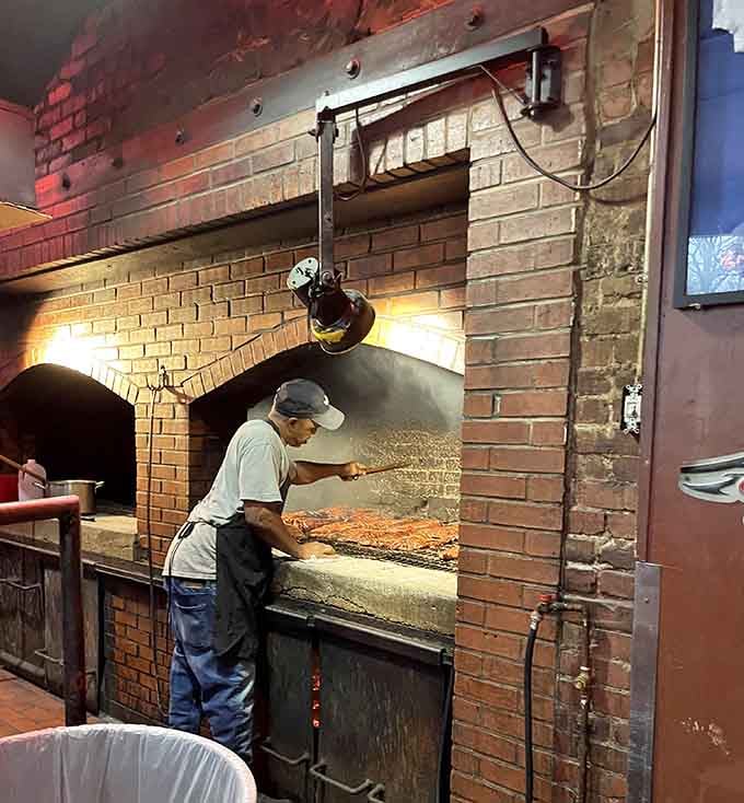 The real MVP: pit masters tending hickory-fired brick ovens, turning raw ribs into the stuff of legend, one slab at a time.