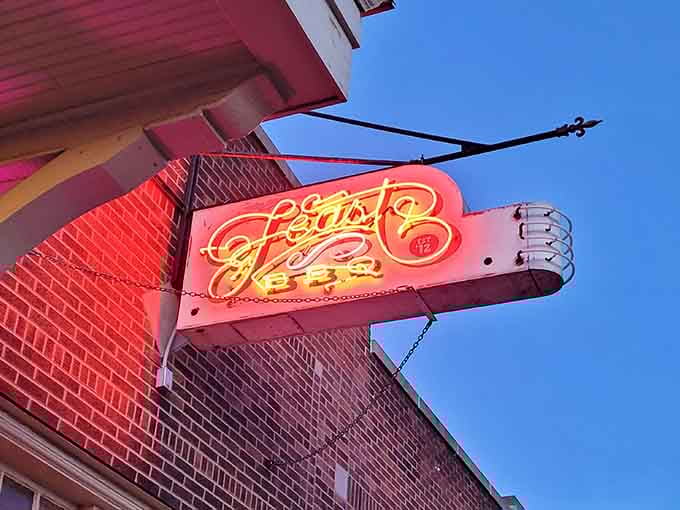 That vintage-style neon sign glowing against the evening sky is basically a beacon calling all barbecue lovers home.