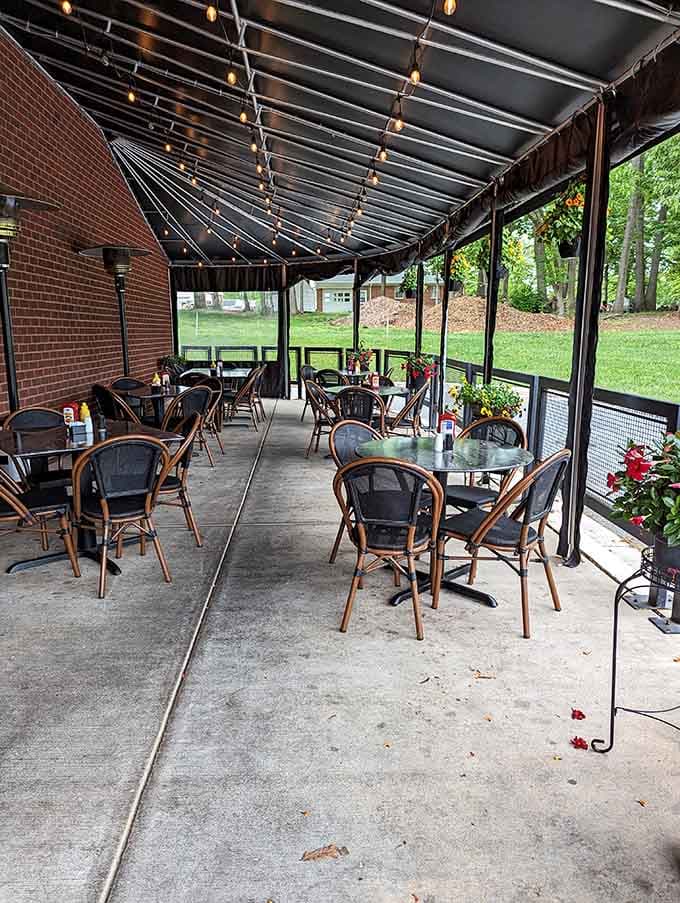 The covered patio offers fresh air dining surrounded by greenery, perfect for savoring those legendary hot dogs.