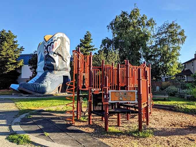 The playground sits in the shadow of towering boots, giving kids the most unusual backdrop for their adventures.