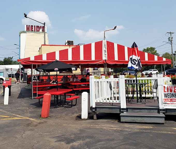 Outdoor seating under red and white striped awnings, because eating great food tastes even better with a side of fresh air.