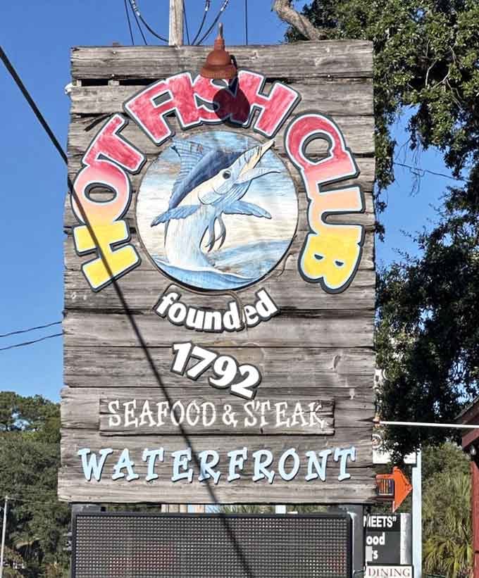 This weathered wooden sign has been pointing hungry travelers toward seafood happiness since way back when flip phones were cool.
