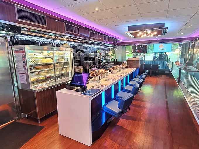 The counter area gleams with possibility, bathed in cool blue light. Where solo diners become temporary members of the breakfast club.
