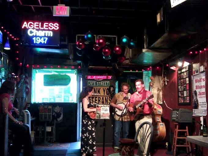 The neon "Ageless Charm" sign isn't just decoration; it's a mission statement this place lives up to nightly.