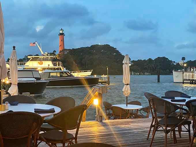 Evening view from the deck as boats pass and the lighthouse stands sentinel over your dinner.