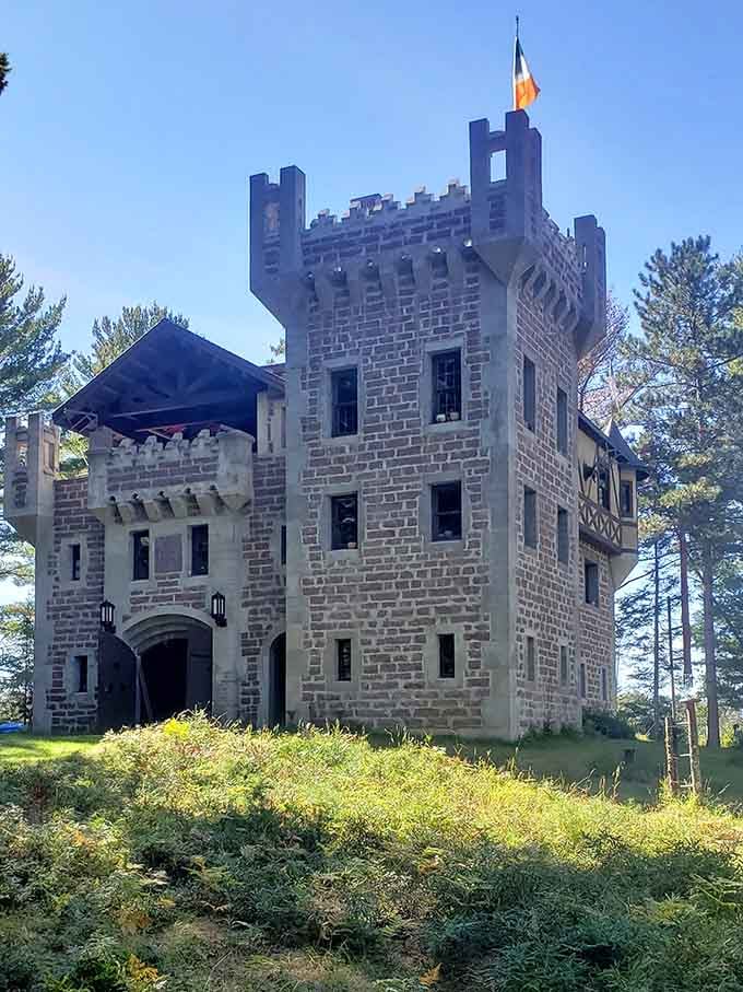 The full castle exterior in all its stone glory, standing proud among Wisconsin pines like it's been there for centuries.