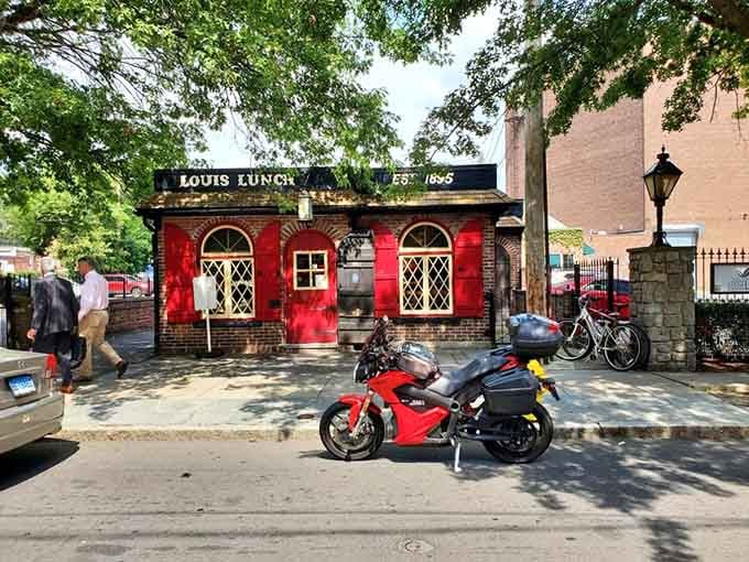 The unassuming exterior belies the monumental culinary significance of what happens inside this tiny New Haven landmark daily.