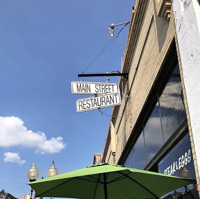 The simple signage hanging above the street has been guiding hungry travelers to breakfast happiness for longer than most remember.