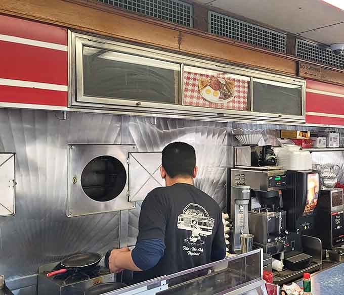 The kitchen crew works in tight quarters with the precision of a submarine crew, minus the torpedoes.