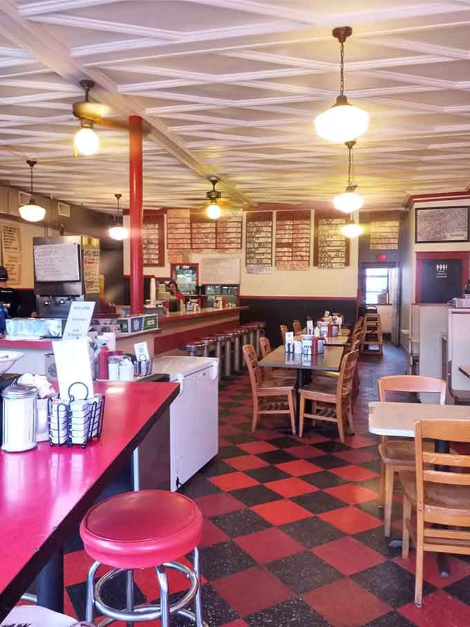 Red and black checkered floors, pendant lights, and counter seating: diner perfection that never goes out of style.