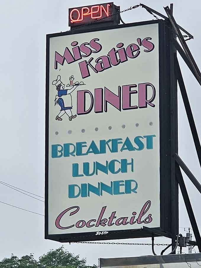 The towering sign announces breakfast, lunch, dinner, and cocktails in cheerful retro lettering.