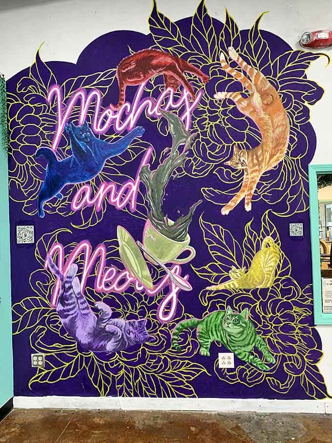 This stunning mural celebrates the cafe's name with artistic flair, turning a simple wall into a colorful tribute to coffee and cats.