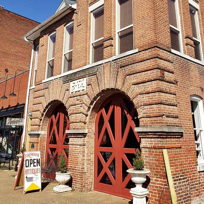 Those distinctive red doors on the old firehouse now welcome antique hunters instead of horse-drawn fire wagons.