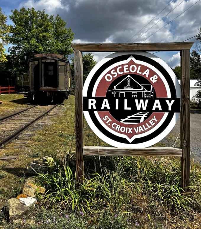The railway's welcoming sign promises authentic experiences, and those vintage cars in the background prove they're not kidding around here.