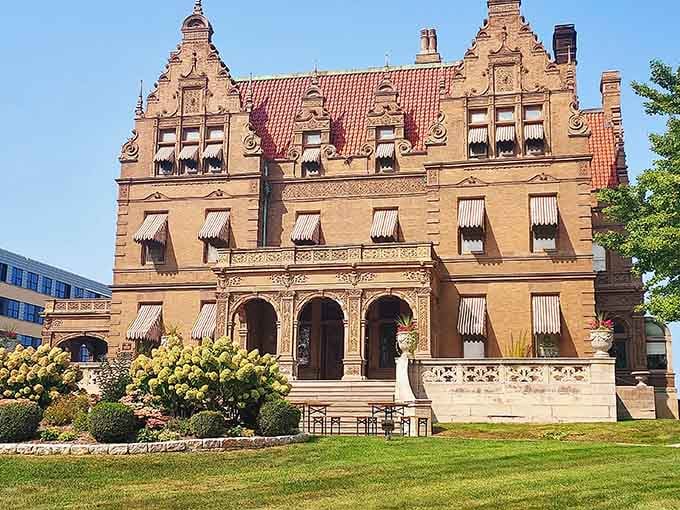 The full facade reminding you that beer money in the Gilded Age built actual castles, not just lake houses.