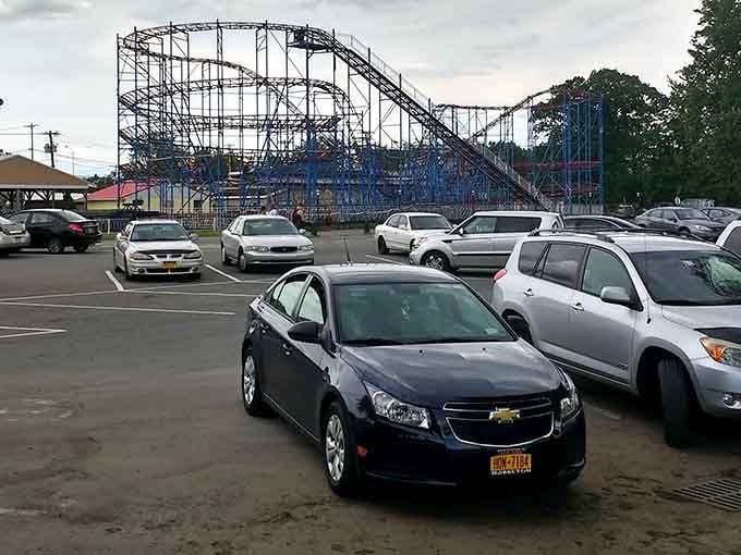 The parking lot view of the roller coaster serves as both welcome and farewell – a steel promise of adventures waiting just steps away.