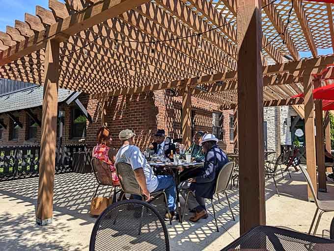 Dappled sunlight through the pergola creates the ideal setting for seafood conversations that inevitably begin with "You have to try this!"
