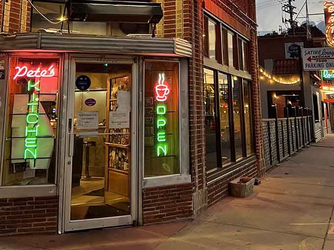 The glowing "OPEN" sign in the window promises hot coffee and comfort anytime, day or night.