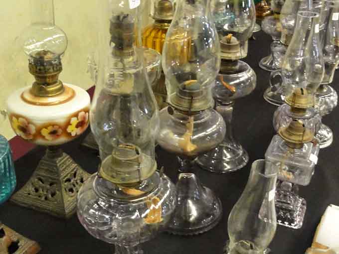Vintage oil lamps lined up like soldiers from a gentler, more flammable era of home lighting.