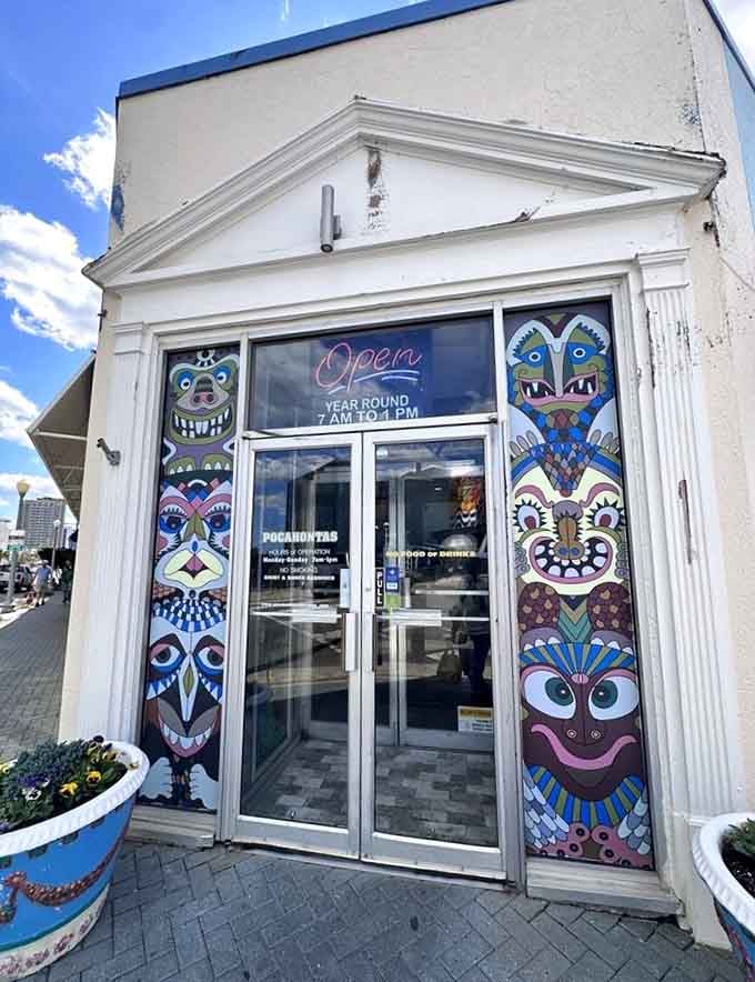 Colorful totem poles flanking the entrance, making it physically impossible to walk past without stopping to investigate what's inside.