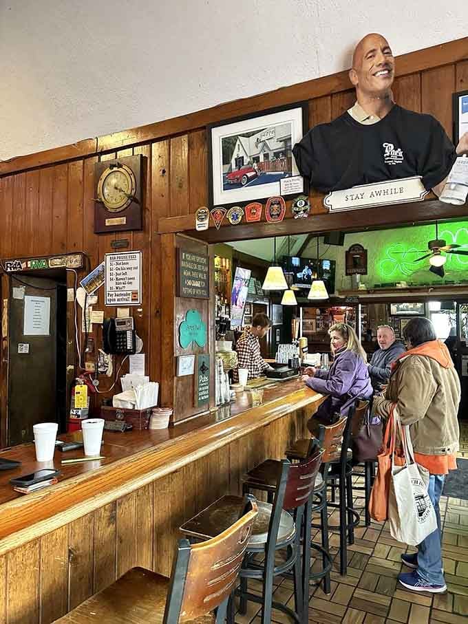 The bar's eclectic decor mixes sports memorabilia with quirky touches, watched over by what appears to be The Rock himself.
